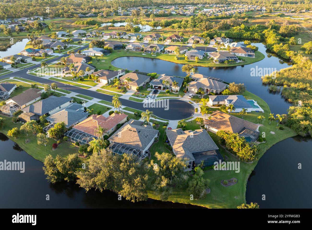 Aerial view of private homes in Florida residential area at sunset. New ...