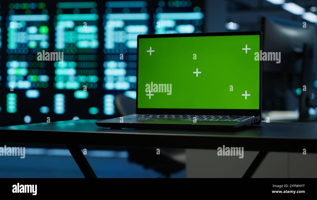 Focus on green screen laptop used by engineers in high tech data center ...