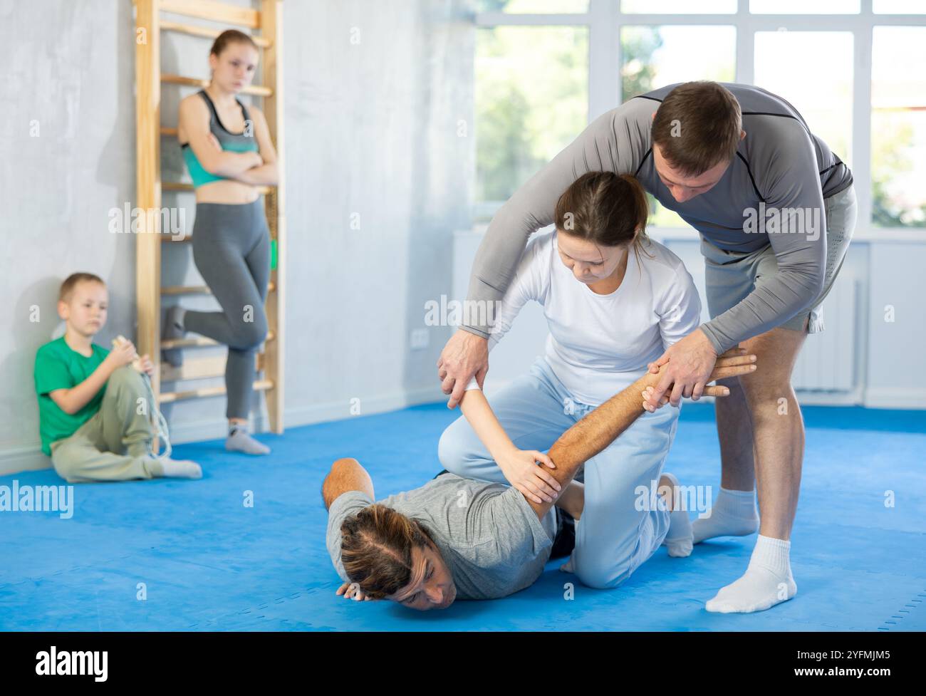 At self-defense training, trainer teaches woman technique of grabbing ...