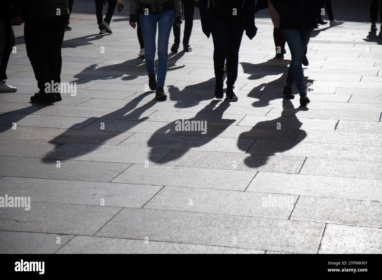 Black silhouettes and shadows of people on the street. Crowd walking ...
