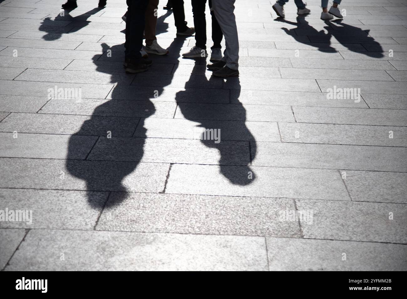 Black silhouettes and shadows of people on the street. Crowd walking ...