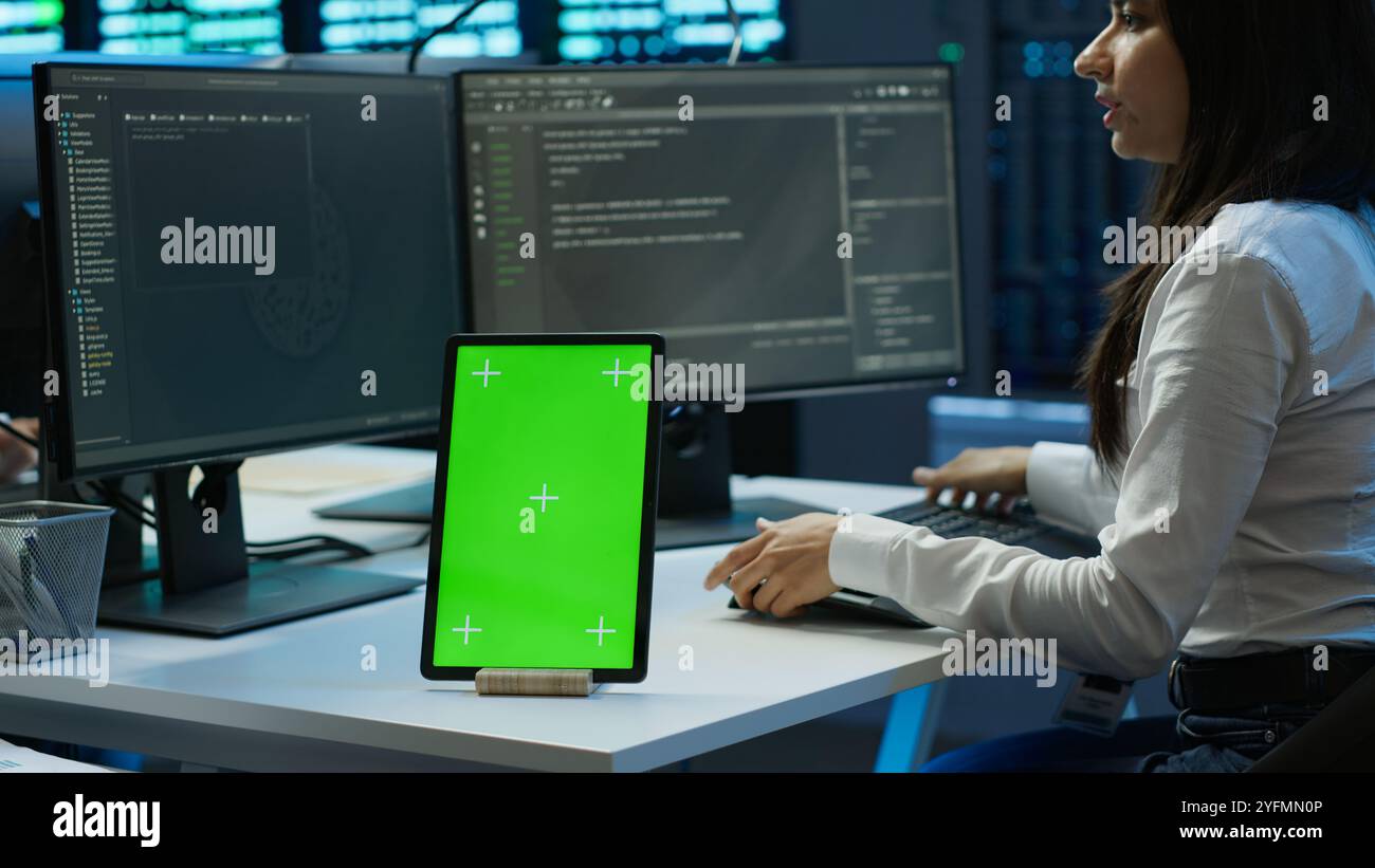 Software developer in data center monitoring security threats using ...
