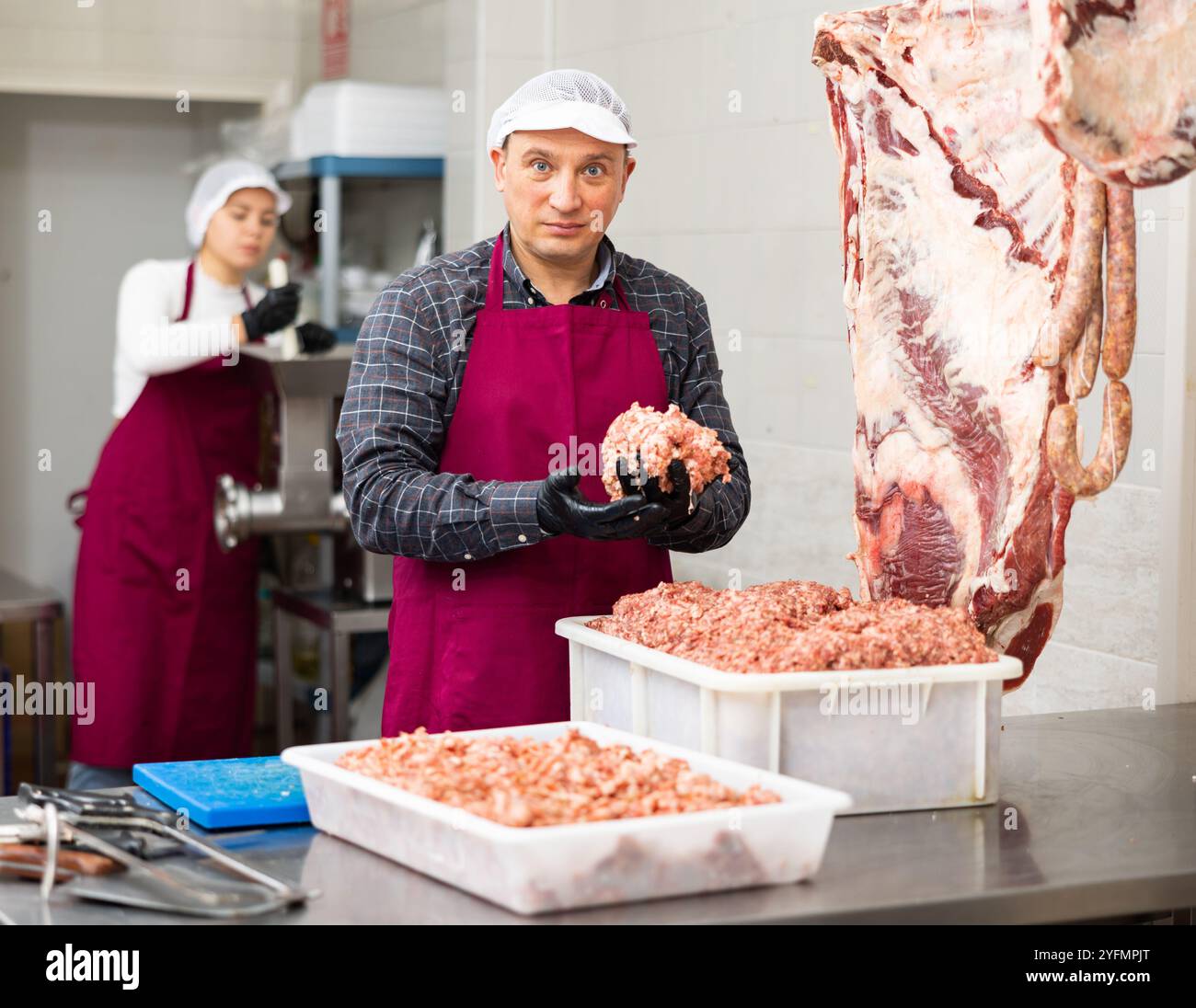 Male butcher holding chunk of minced beef in butchery Stock Photo - Alamy