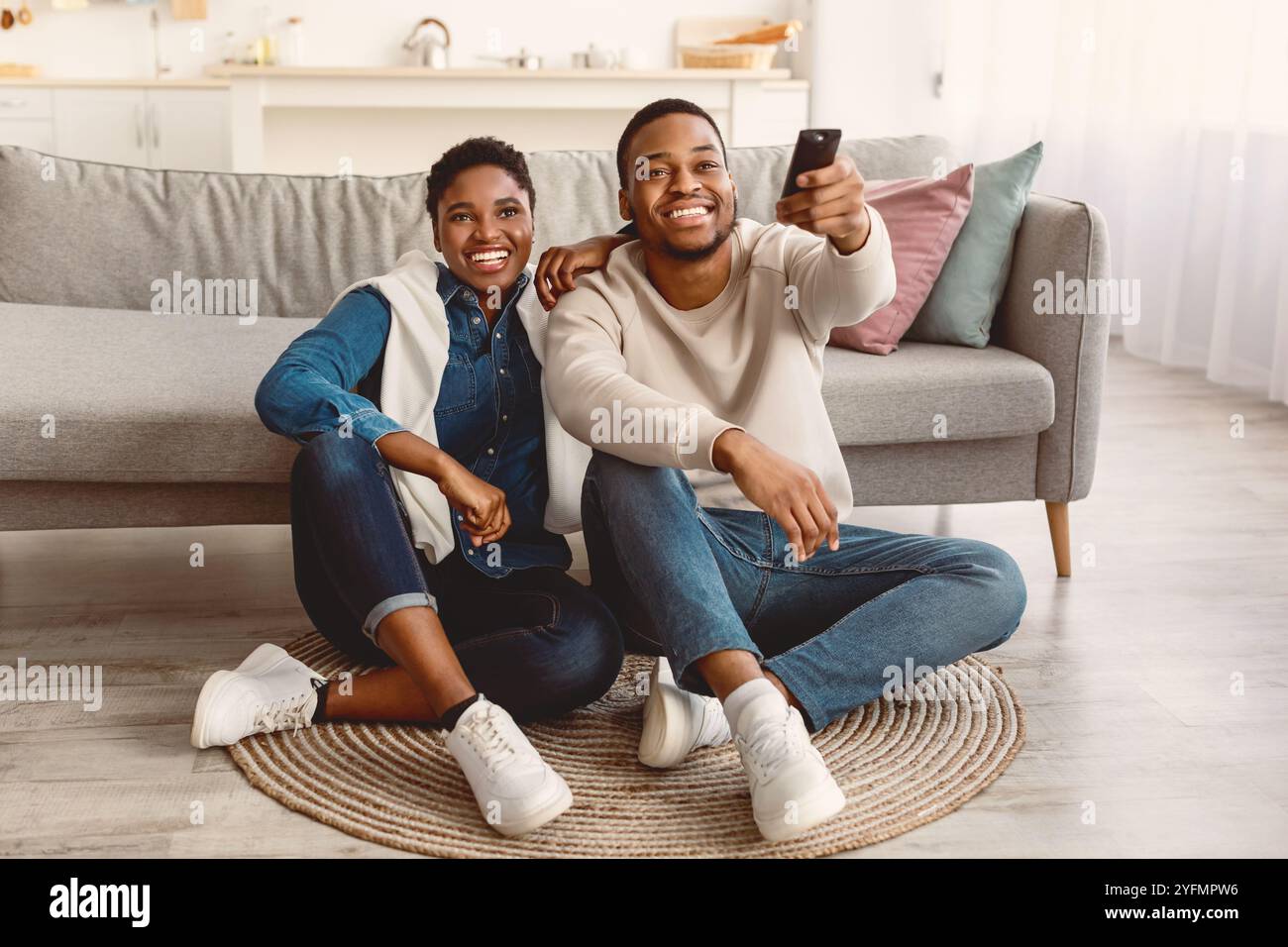Happy black couple spending weekend together watching tv Stock Photo ...