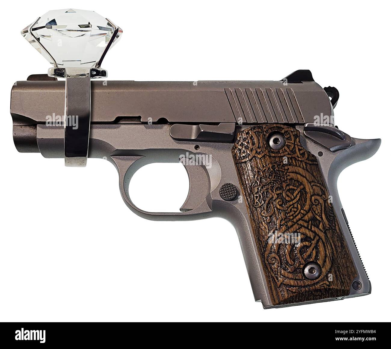 Silver metal gun with Celtic Engraved grip and clip Stock Photo - Alamy