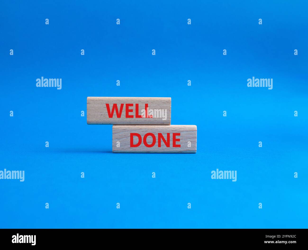 Well done symbol. Wooden blocks with words Well done. Beautiful blue ...