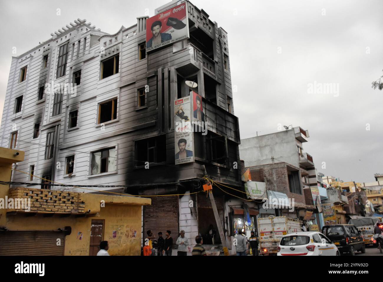 Scene of a building after it was set on fire by a mob during riots in ...
