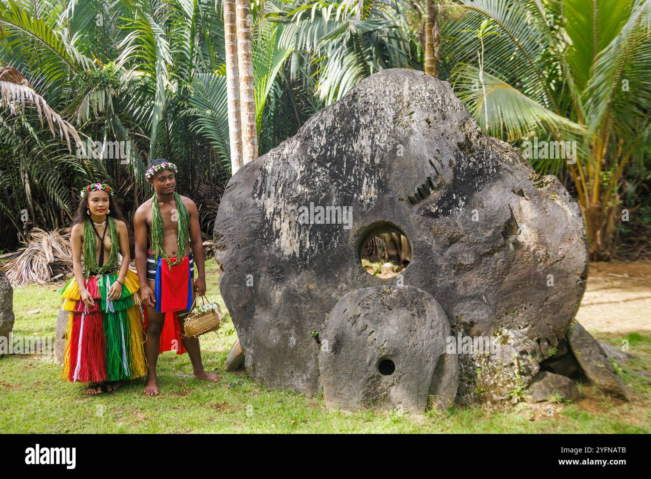 Native Yapese couple in traditional clothing, pictured with stone money ...