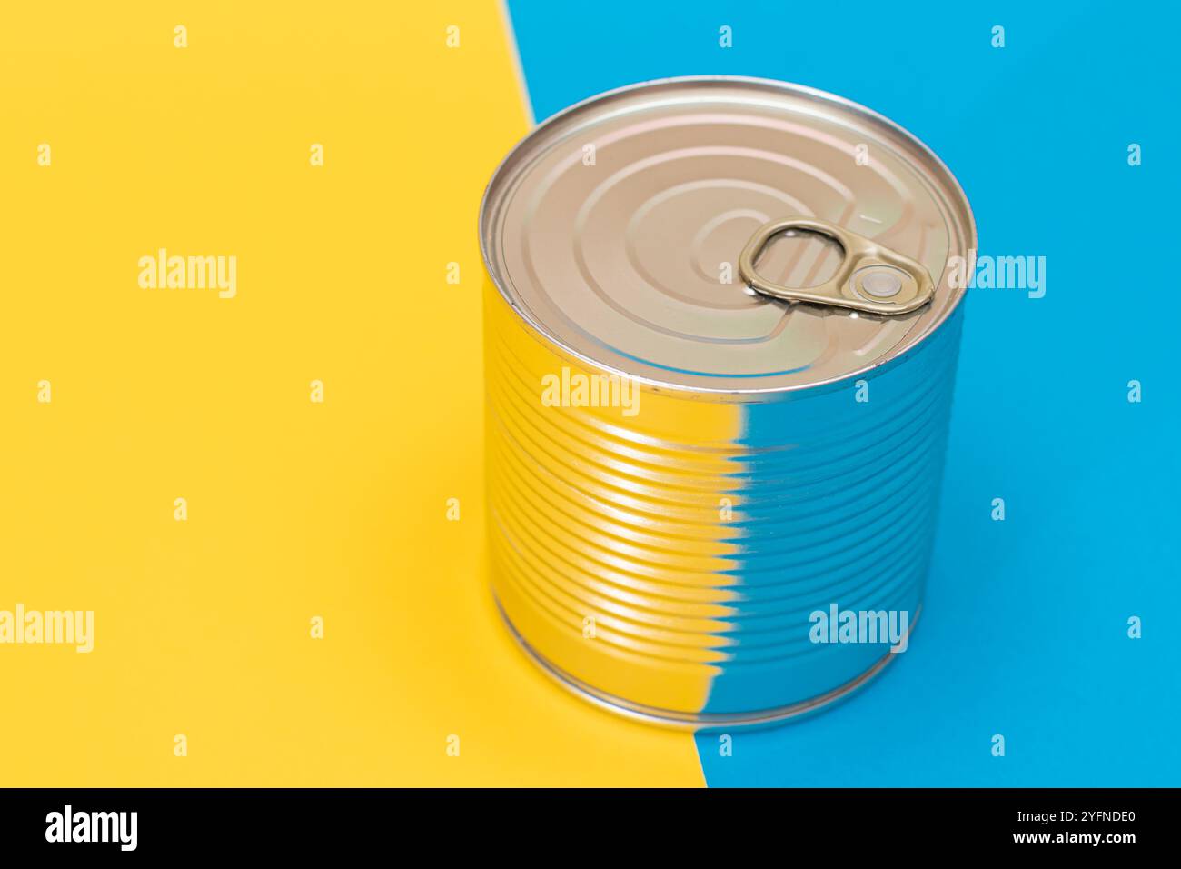 Tin Can on Split Blue and Yellow Background. Canned Food. Aluminum Can ...