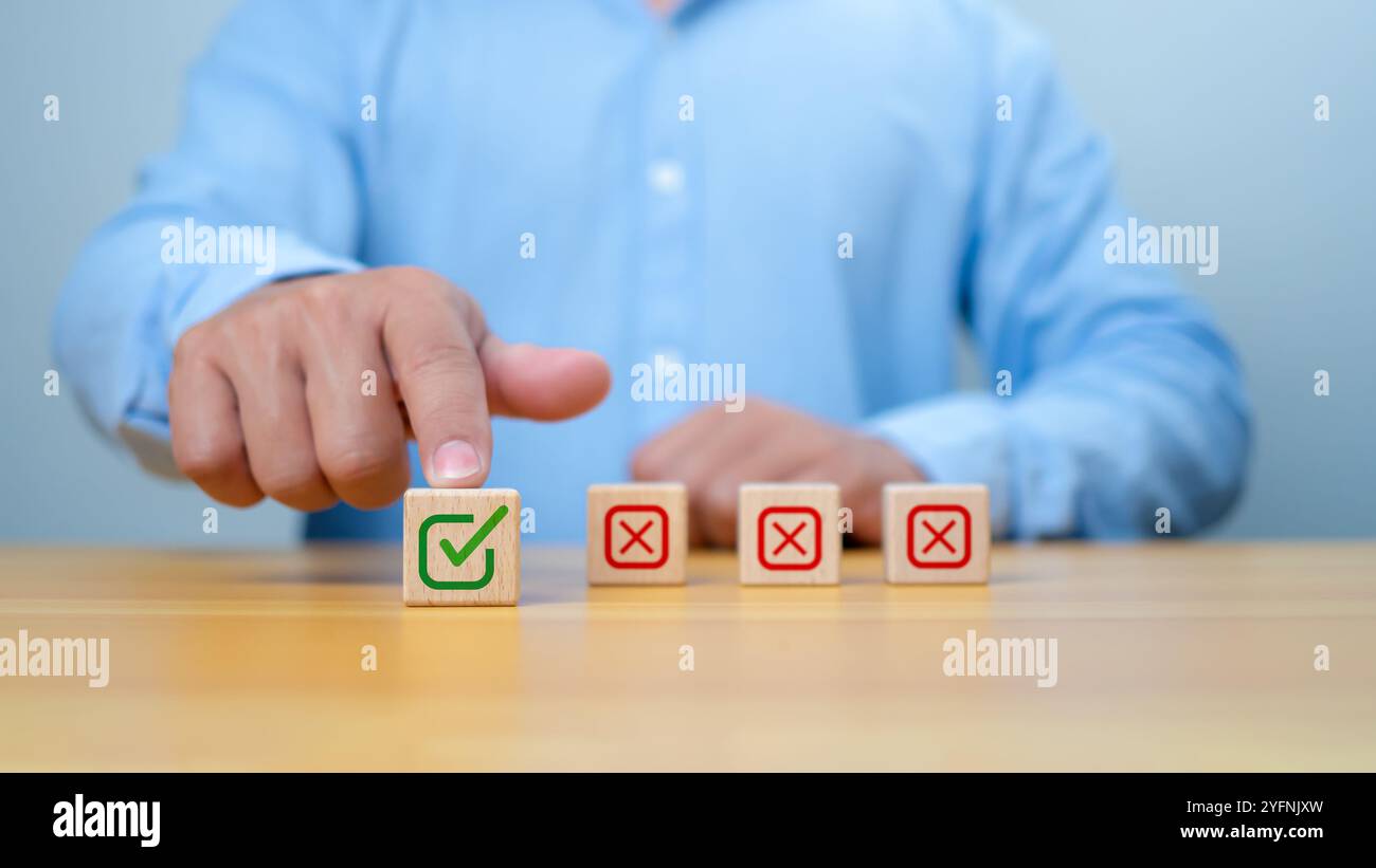 Businessman select green correct sign mark print on wooden block for ...