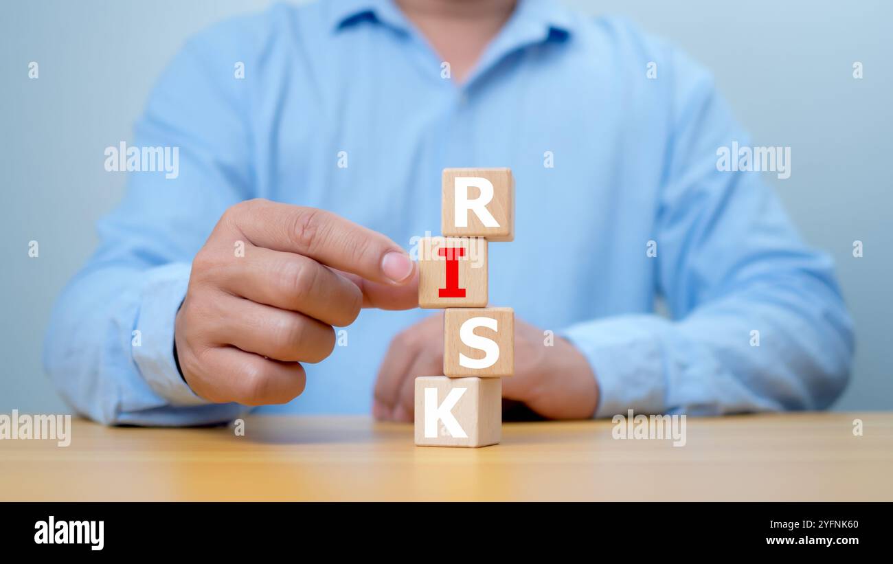 Risk management concept, RISK word print on wooden block on coins money ...