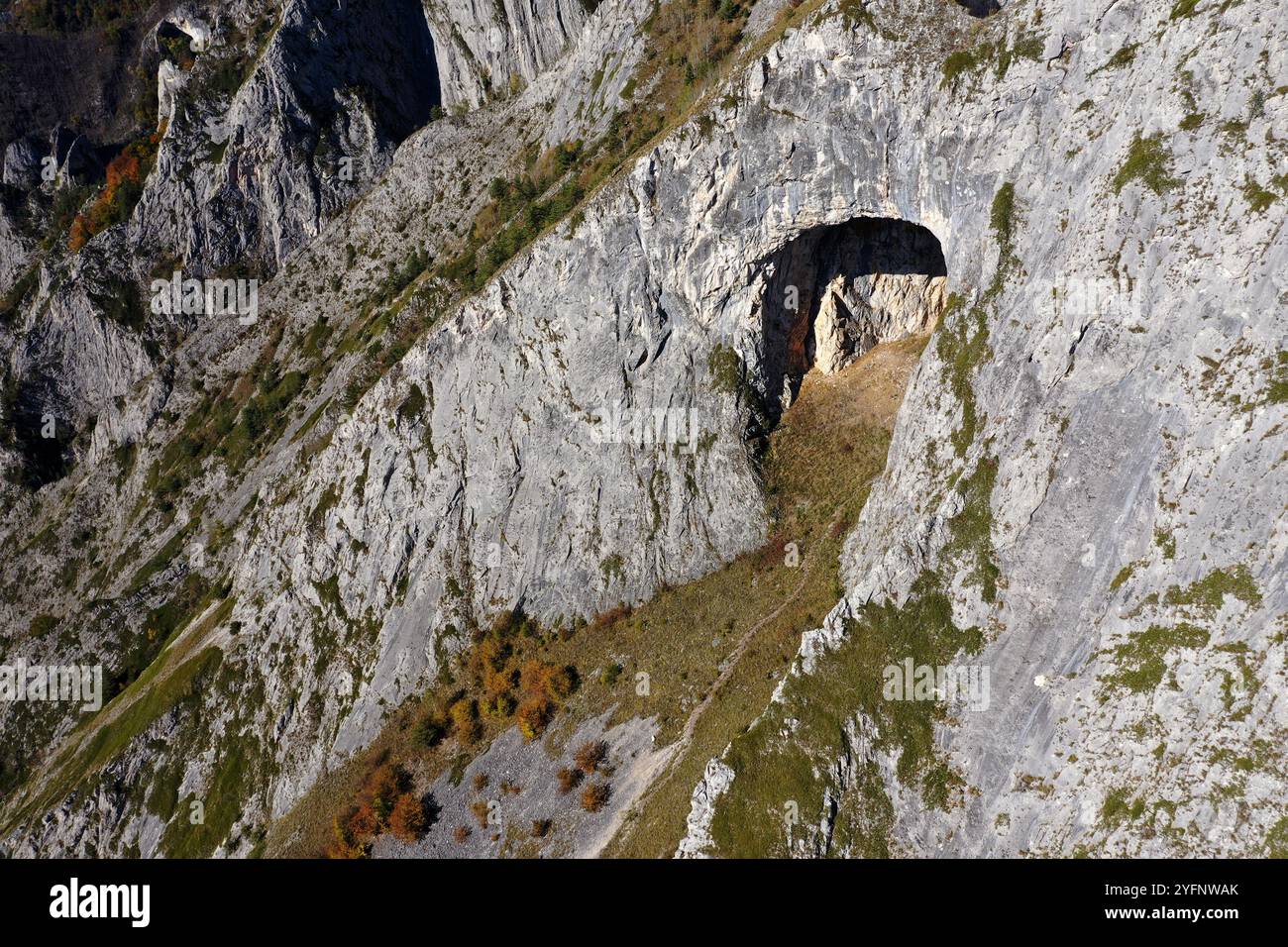 Aerial view of big cave entrance in mountain side by drone Stock Photo ...