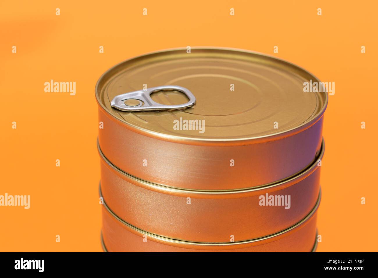 A Group of Stacked Tin Cans with Blank Edges on Orange Background ...