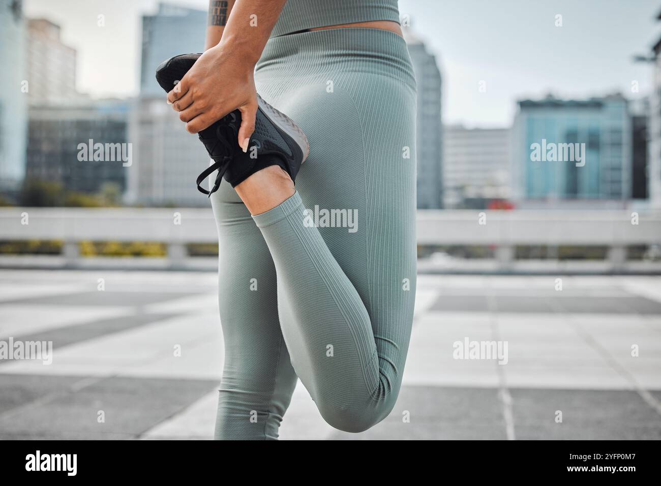 Woman, legs and stretching in city for fitness, warm up and start on ...