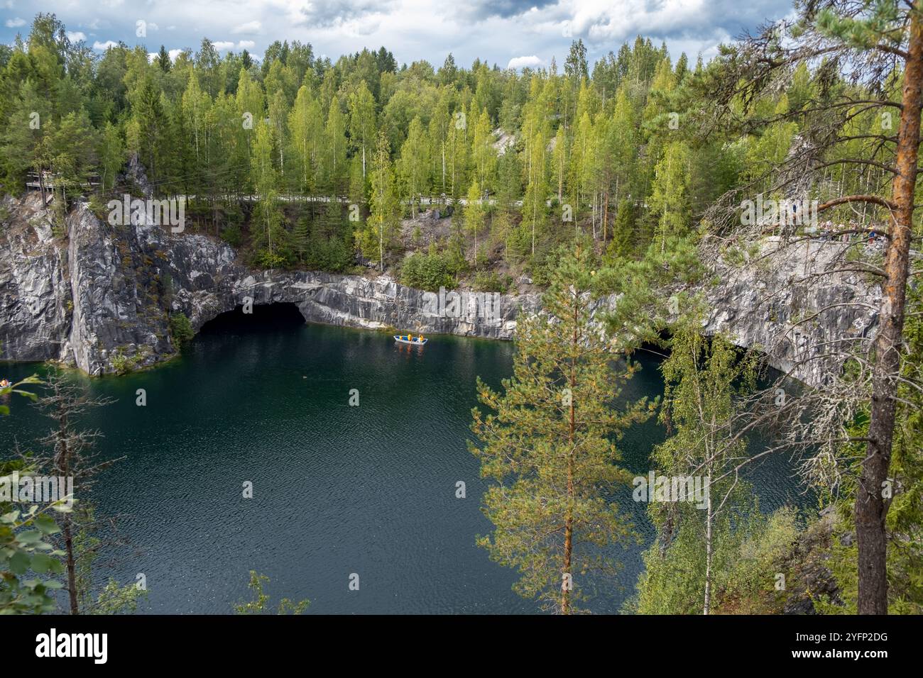 Visitors admire the stunning Marble Canyon in Ruskeala Mountain Park ...