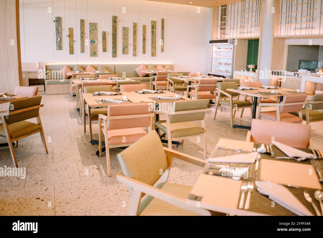 Elegant hotel restaurant interior with neatly arranged tables, warm ...