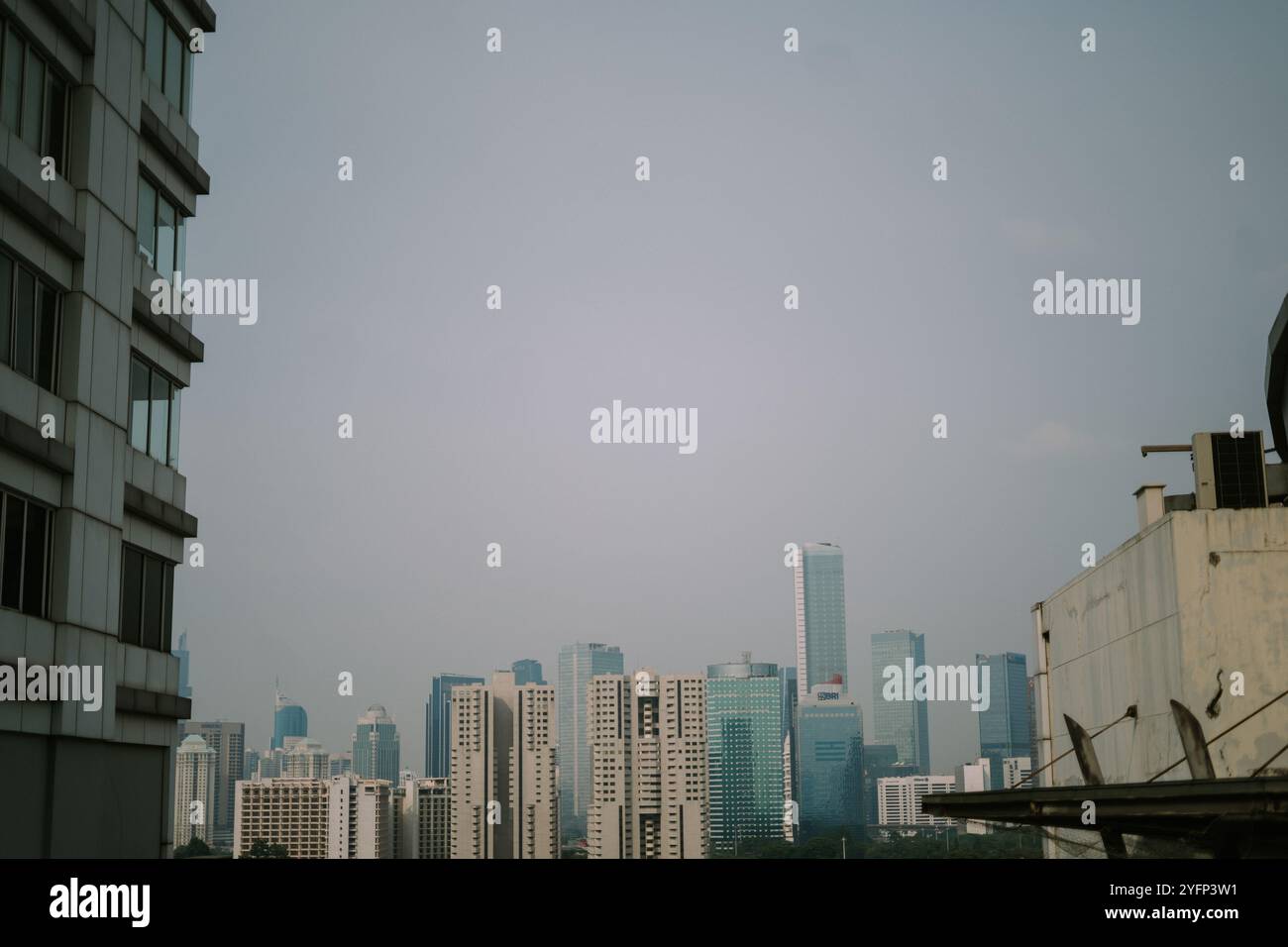 High-rise buildings and a major road in Jakarta city, with visible air ...