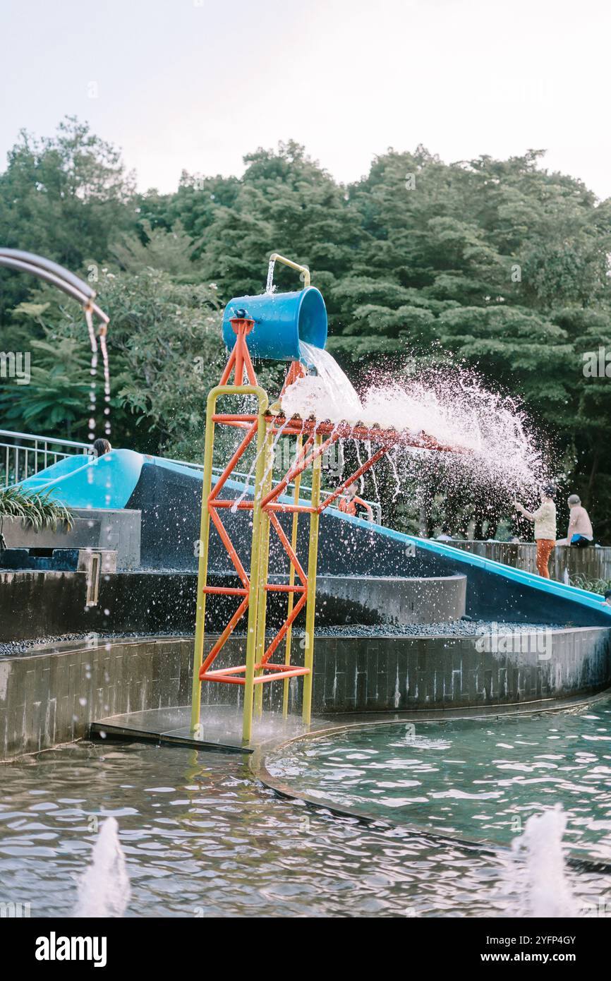 Bogor, October 26, 2024. Artificial waterfall pouring from a bucket ...