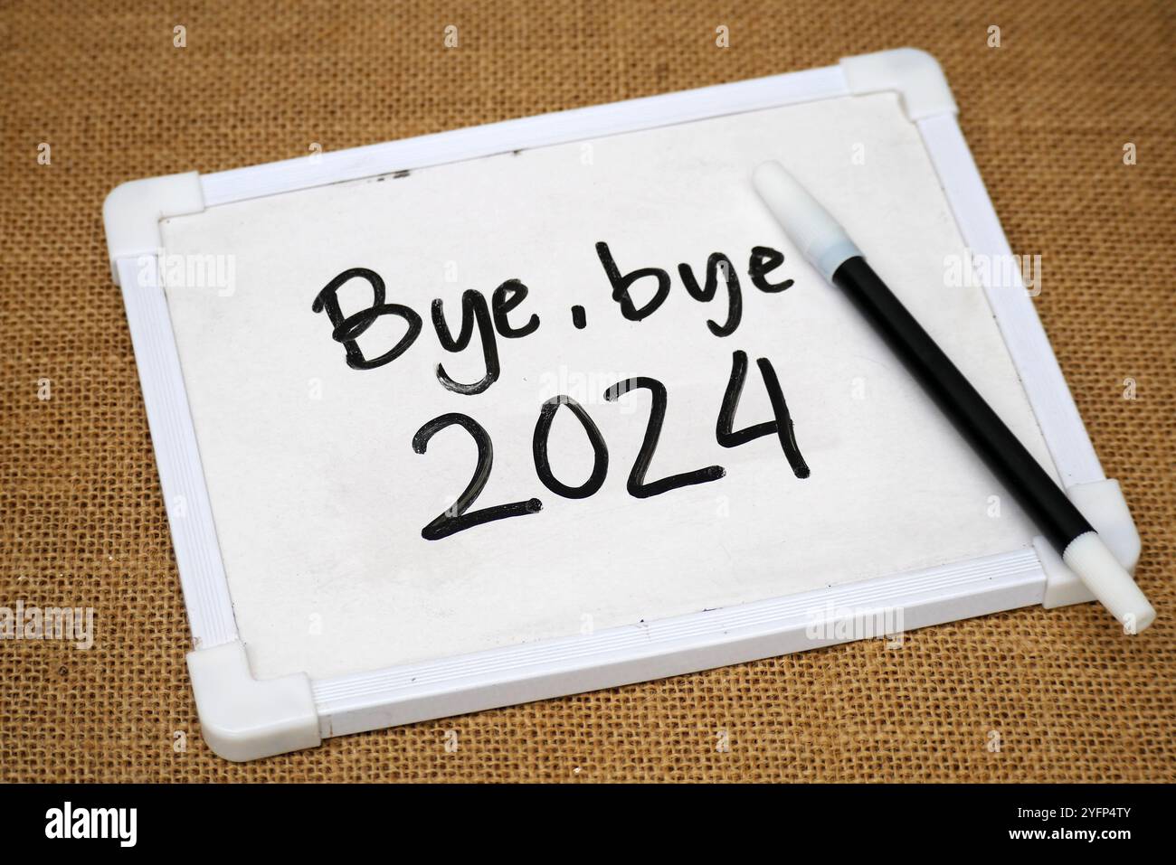handwritten text Bye-bye 2024 on a whiteboard with pen Stock Photo - Alamy