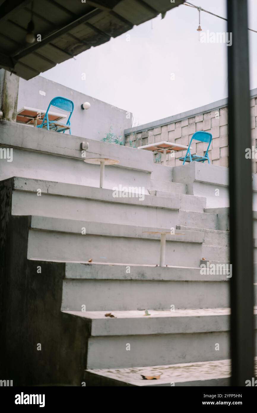 Outdoor seating area with minimalist concrete benches and tables ...