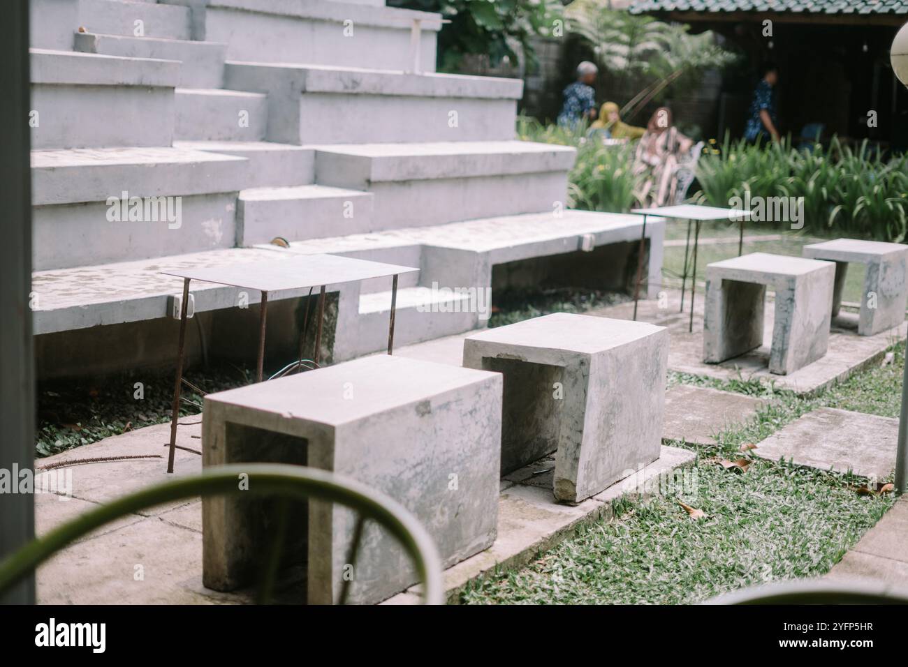 Outdoor seating area with minimalist concrete benches and tables ...