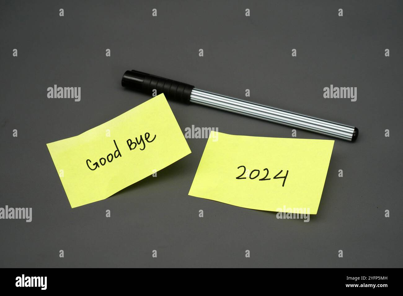 goodbye 2024 handwritten text on yellow stick note Stock Photo - Alamy