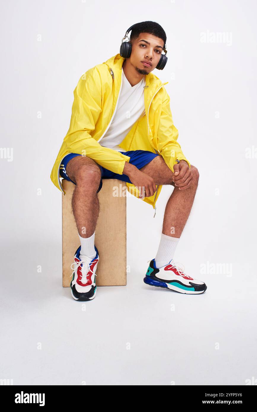Portrait, fashion and man with headphones, listening to music and relax ...