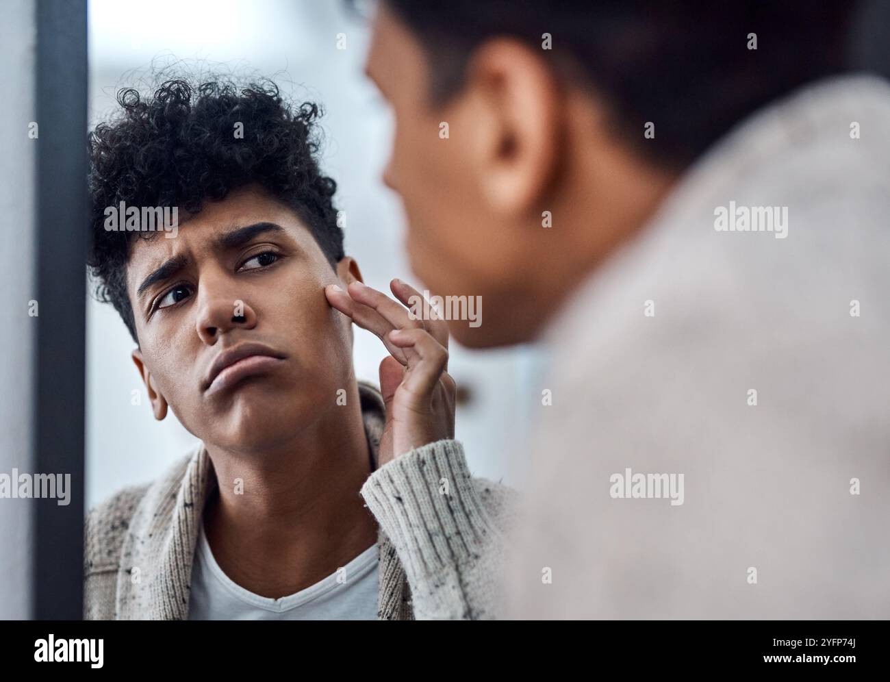 Man, mirror and sad in bathroom for acne, skin problem and facial scar ...