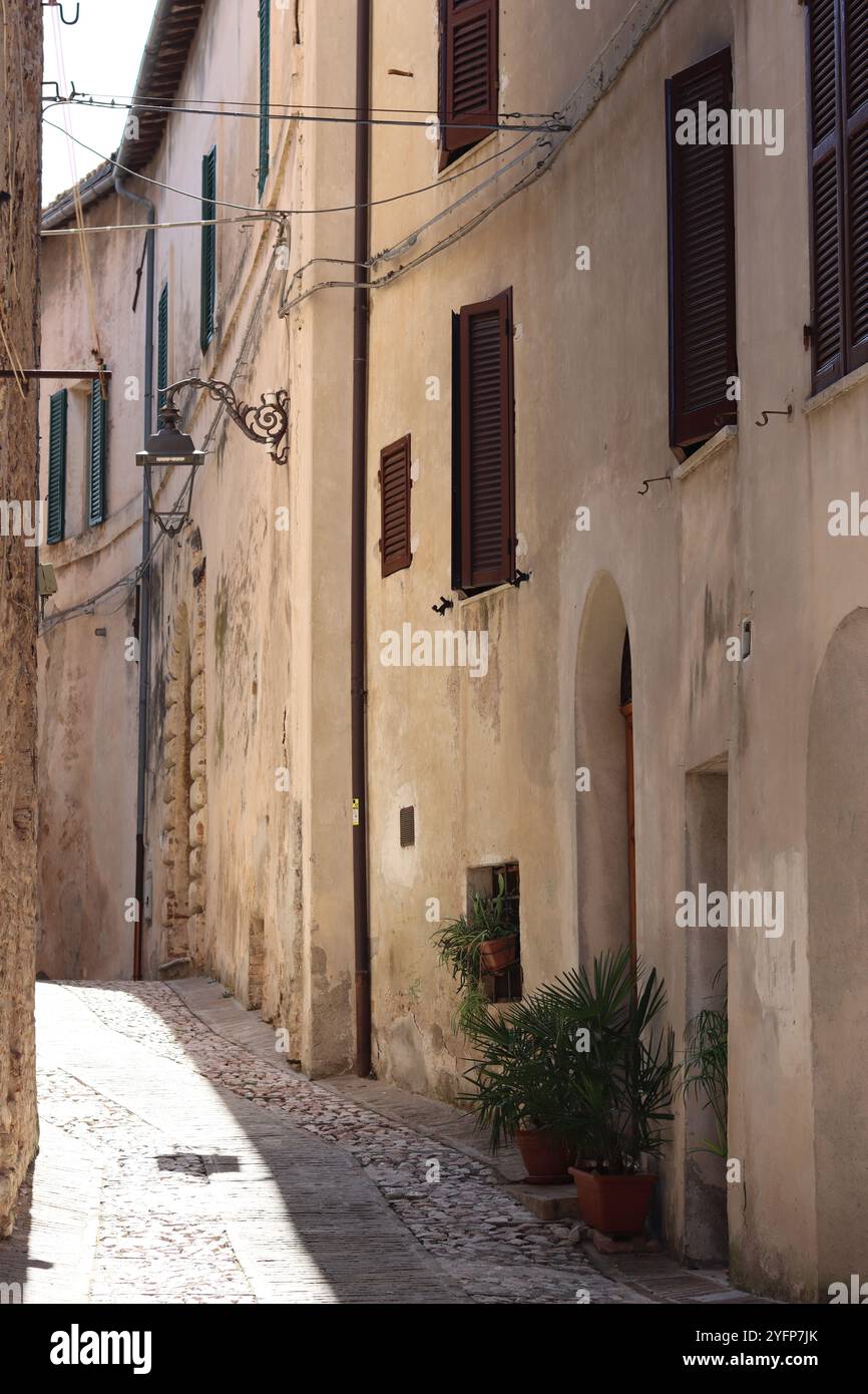 View along a narrow back street in an old town, Umbria, Italy Stock ...