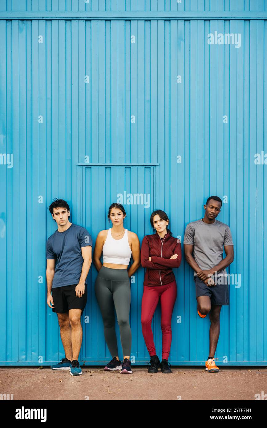 Portrait of a group of serious-looking athletes stands side by side ...
