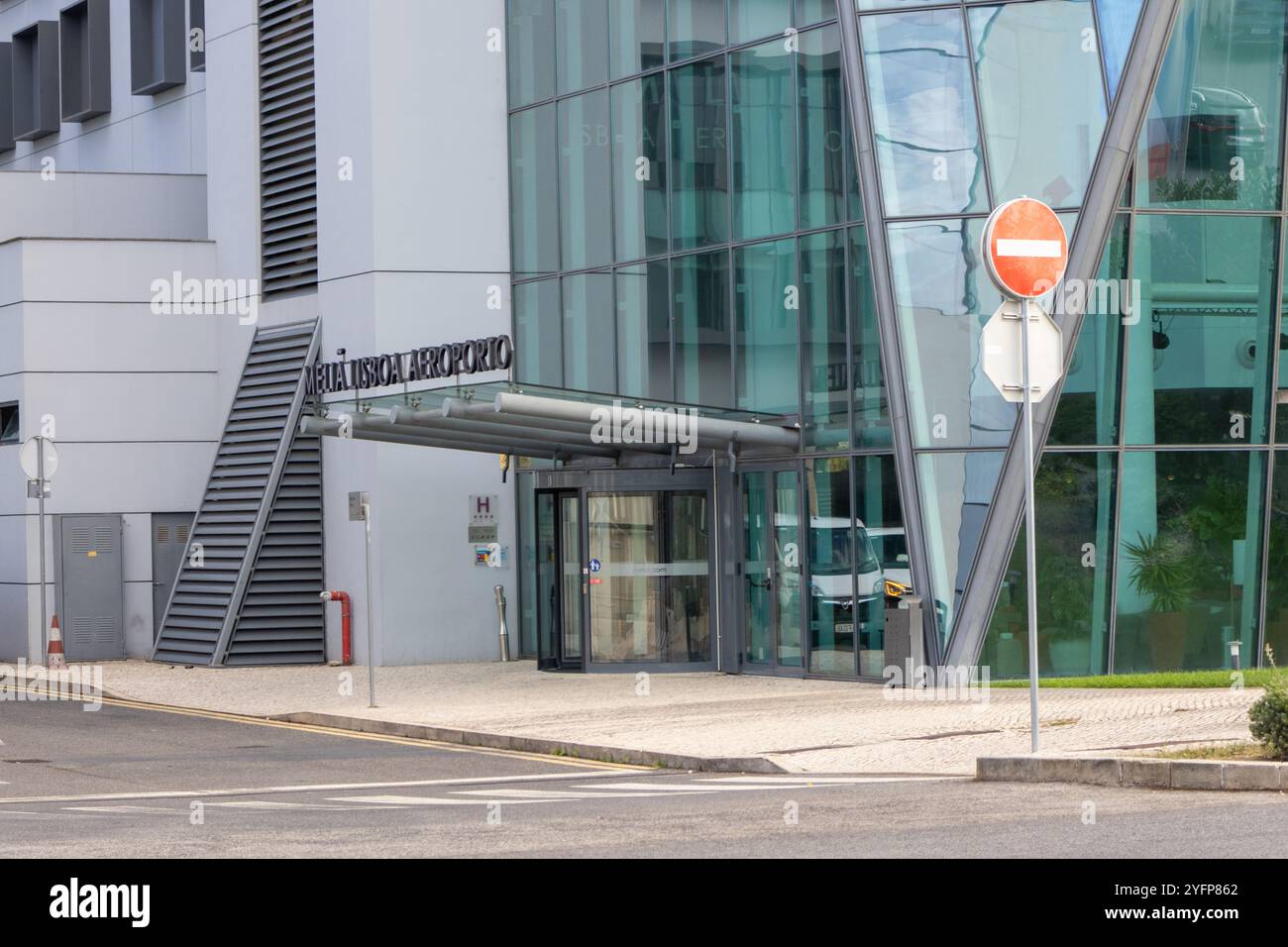 Modern medical facility building exterior with revolving door entrance ...