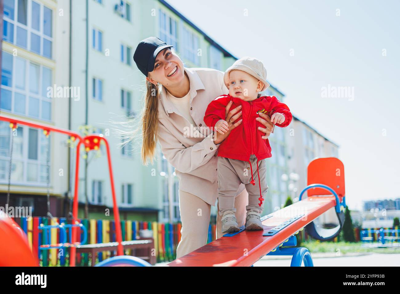 A mother teaches her little son how to play the chords. Baby's first ...
