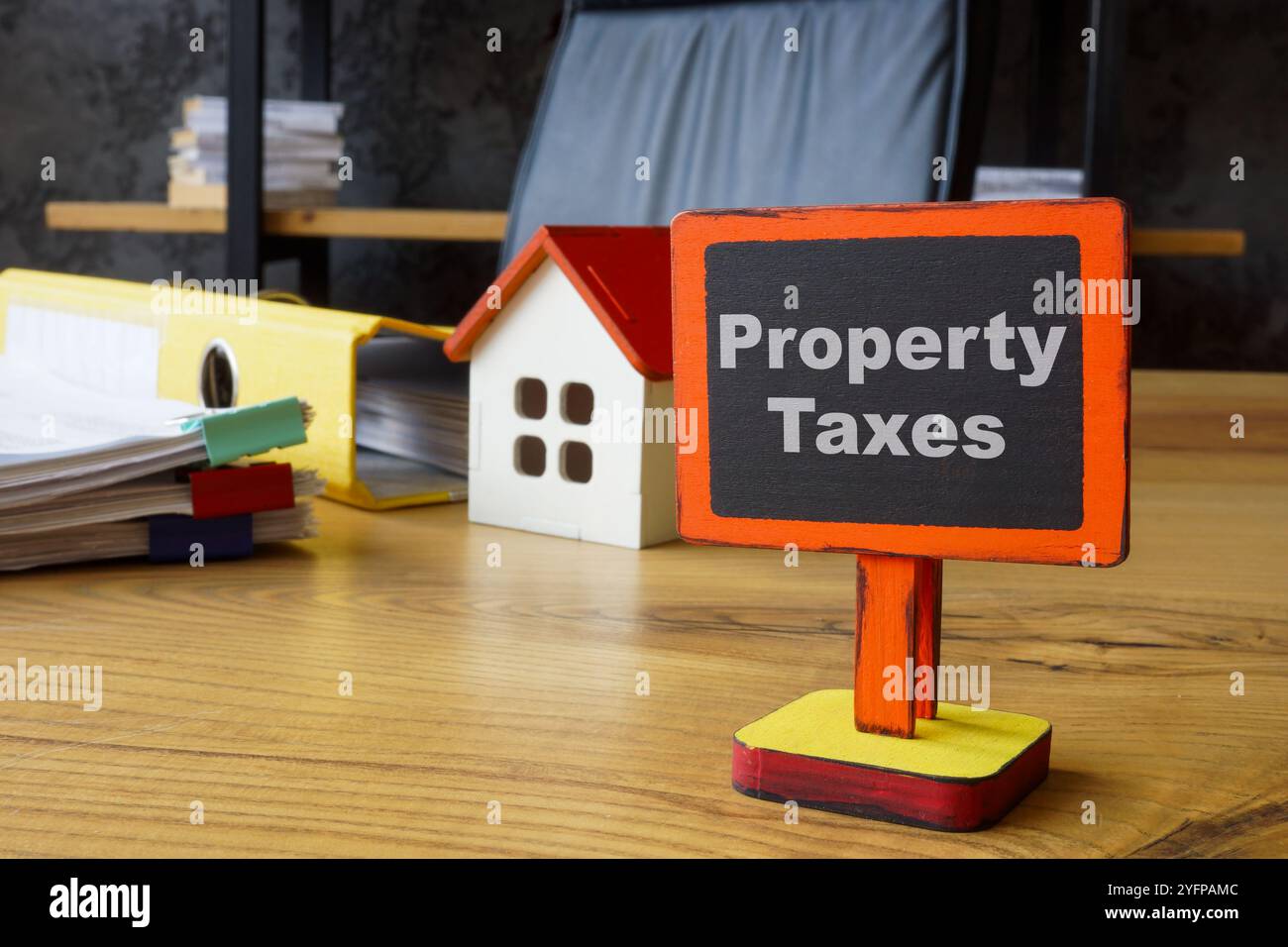 Property taxes sign and house model Stock Photo - Alamy