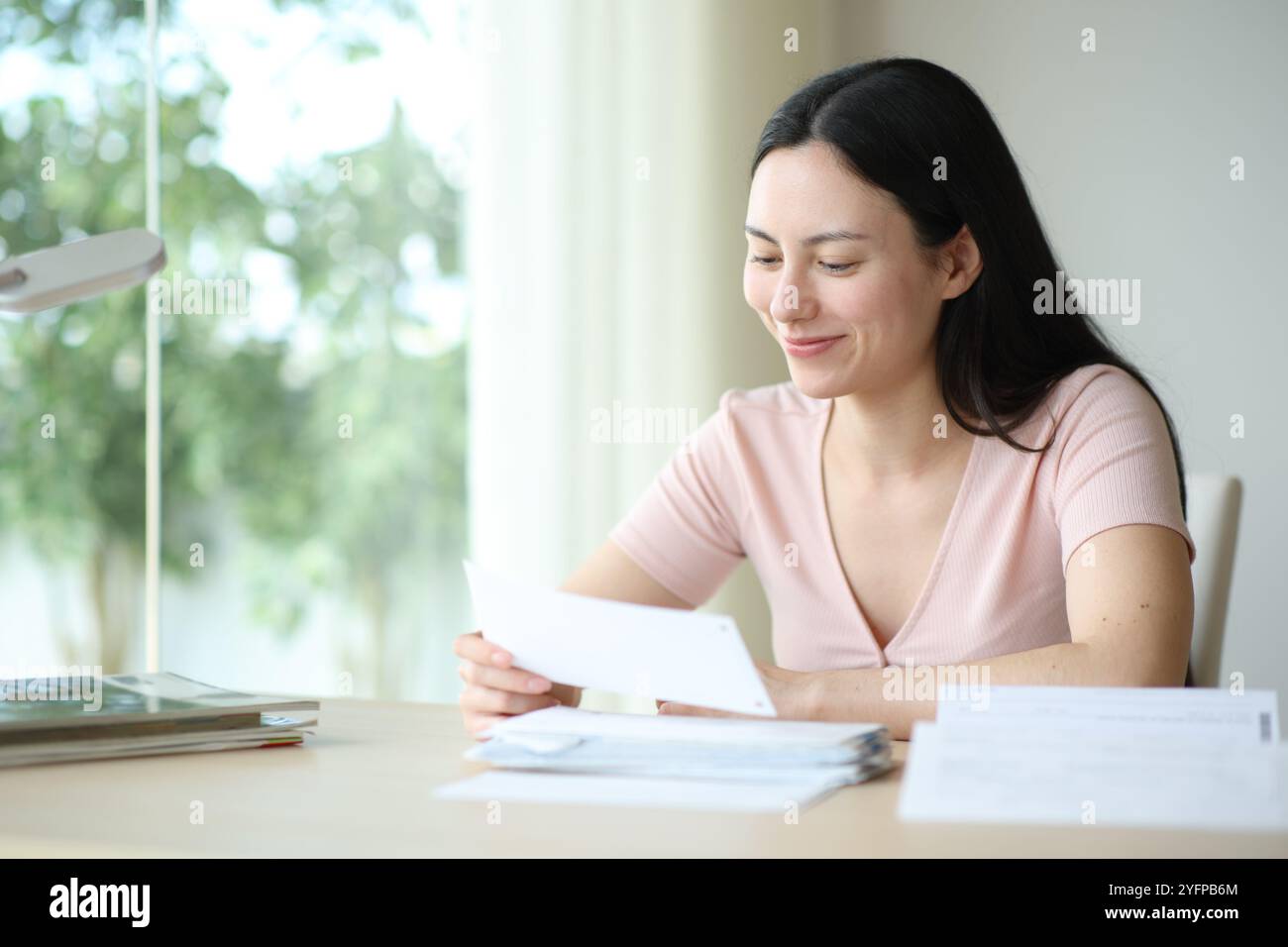 Asian woman checking receipt in a desk at home Stock Photo - Alamy