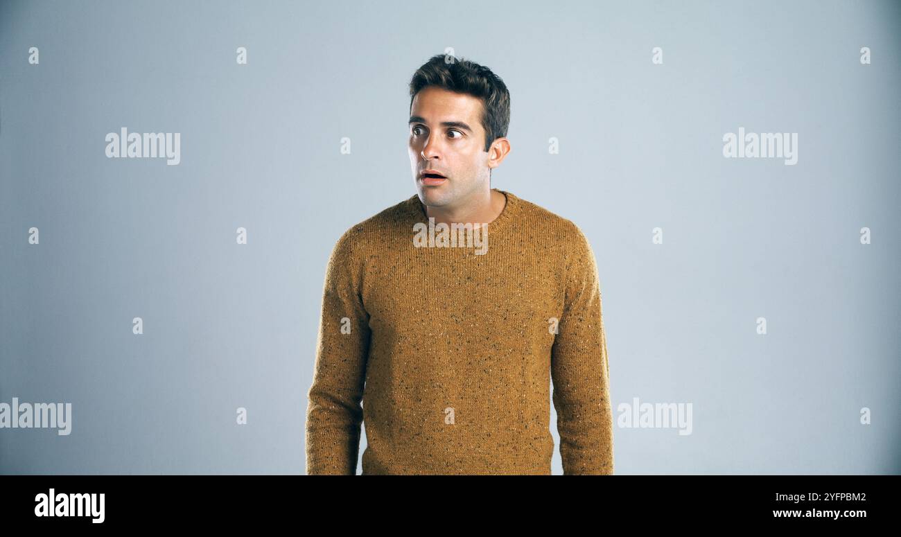 Scared, man and anxiety with fear in studio for horror, terror and ...