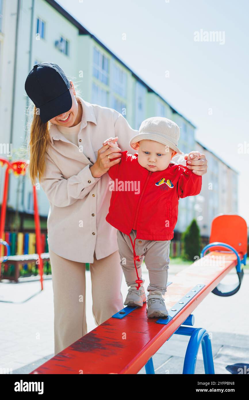 A mother teaches her little son how to play the chords. Baby's first ...