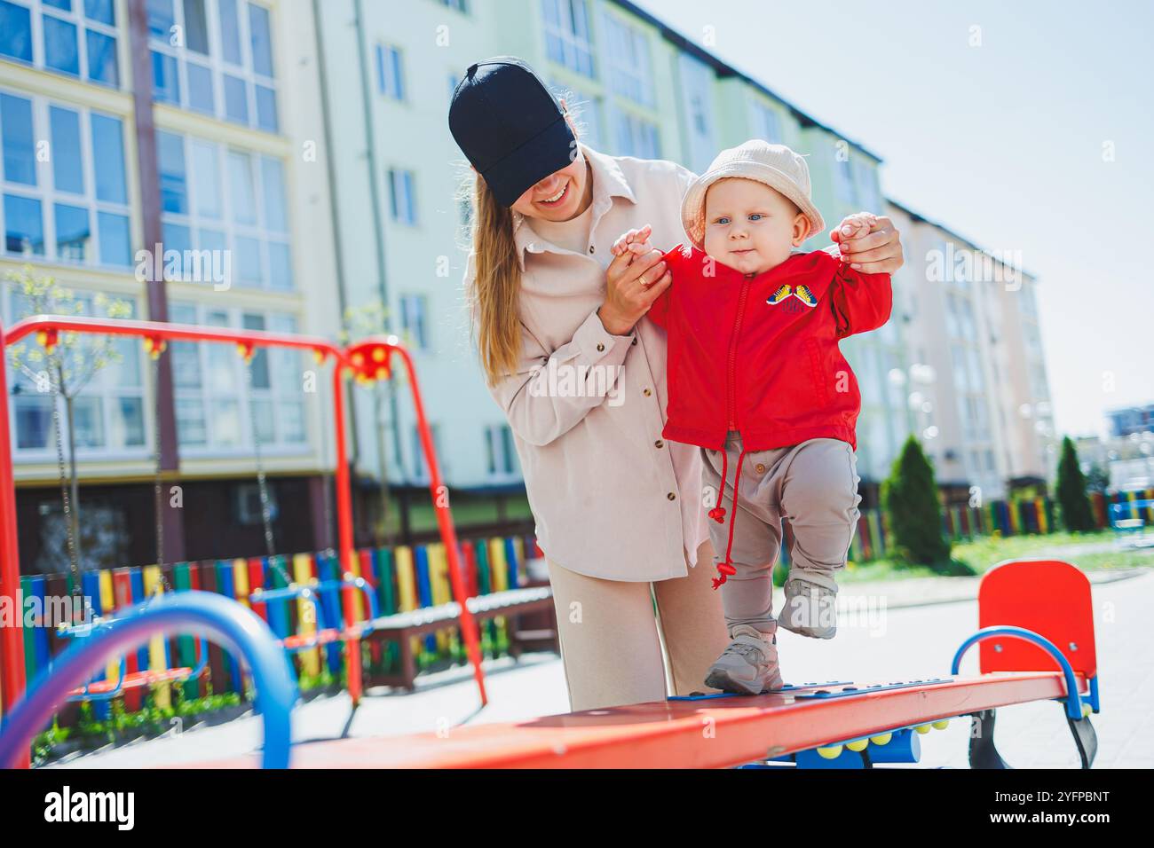A mother teaches her little son how to play the chords. Baby's first ...
