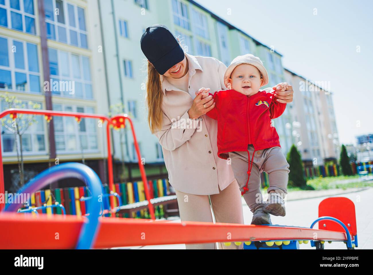 A mother teaches her little son how to play the chords. Baby's first ...