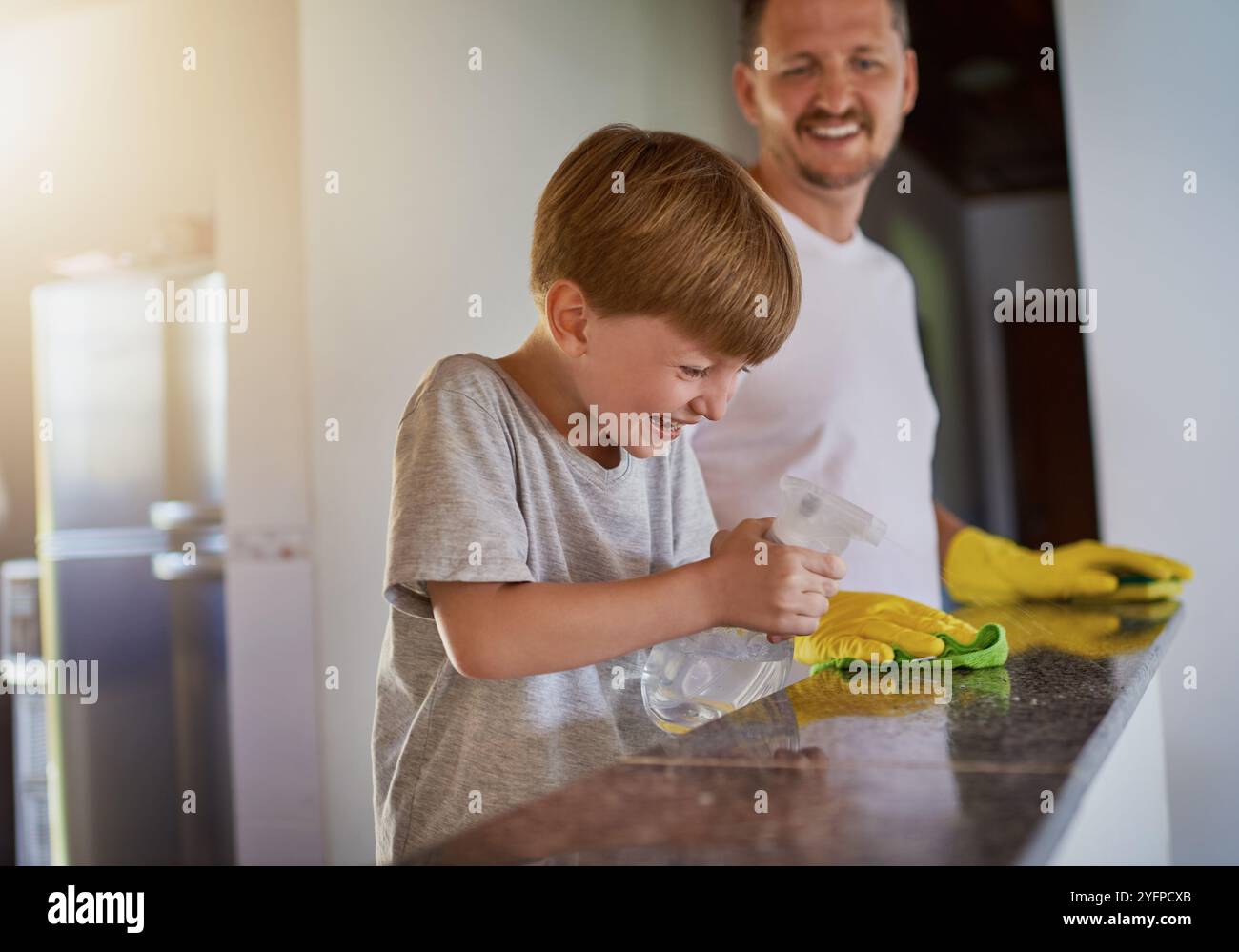 Father, kid and cleaning table with spray in home for helping hand ...