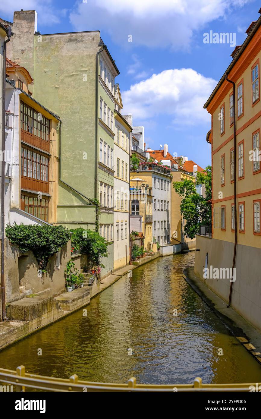 Charming view of Prague's Vltava River, lined with historic buildings ...
