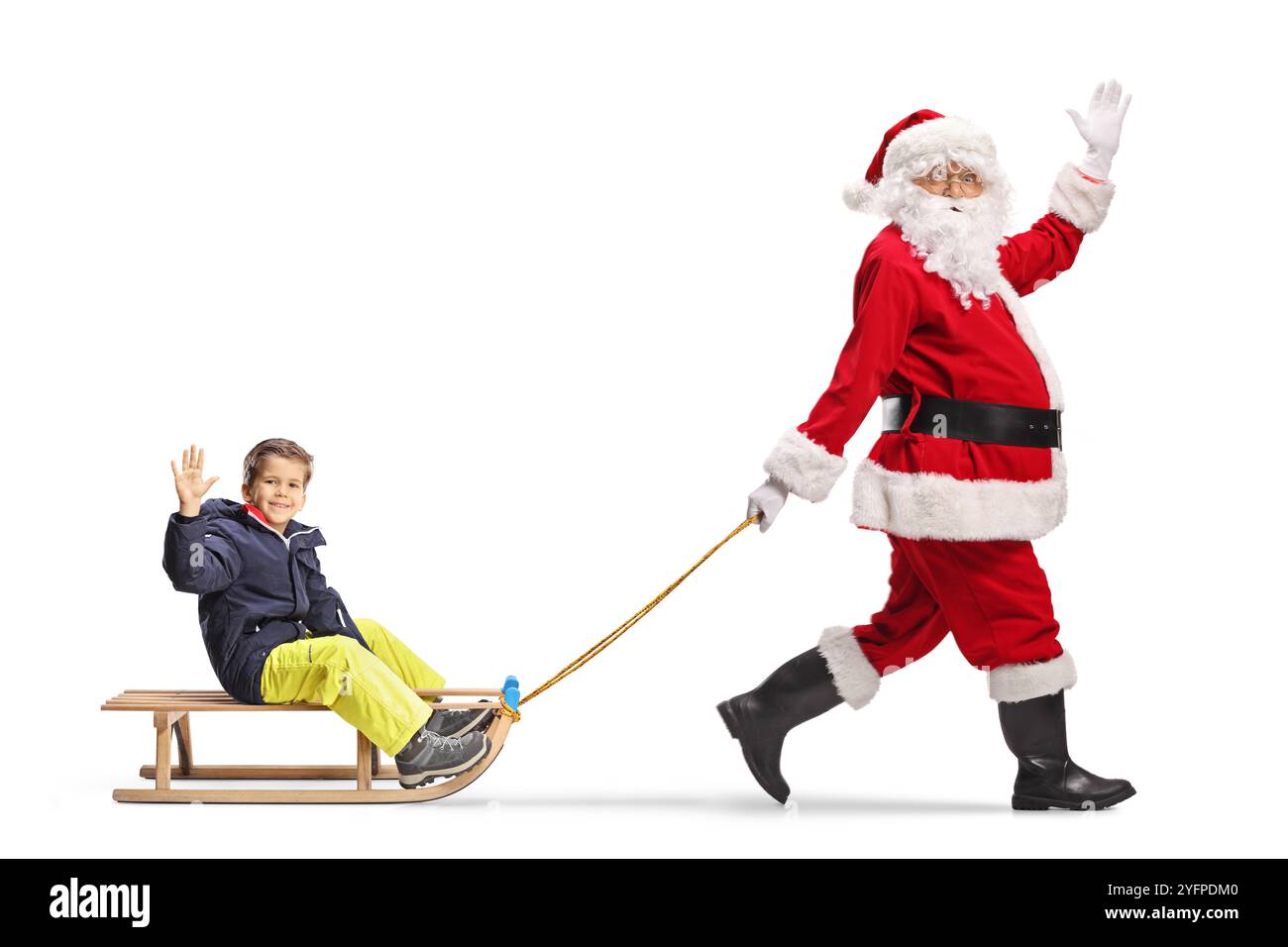 Santa Claus pulling a boy on a wooden sled and waving isolated on white ...