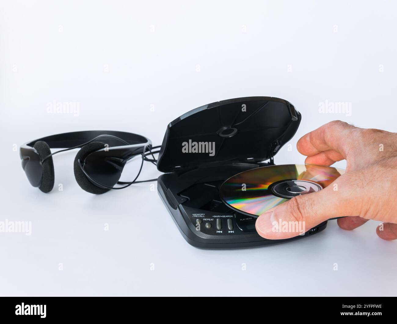 Close up of a man's hand inserting a compact disc into a compact disc ...