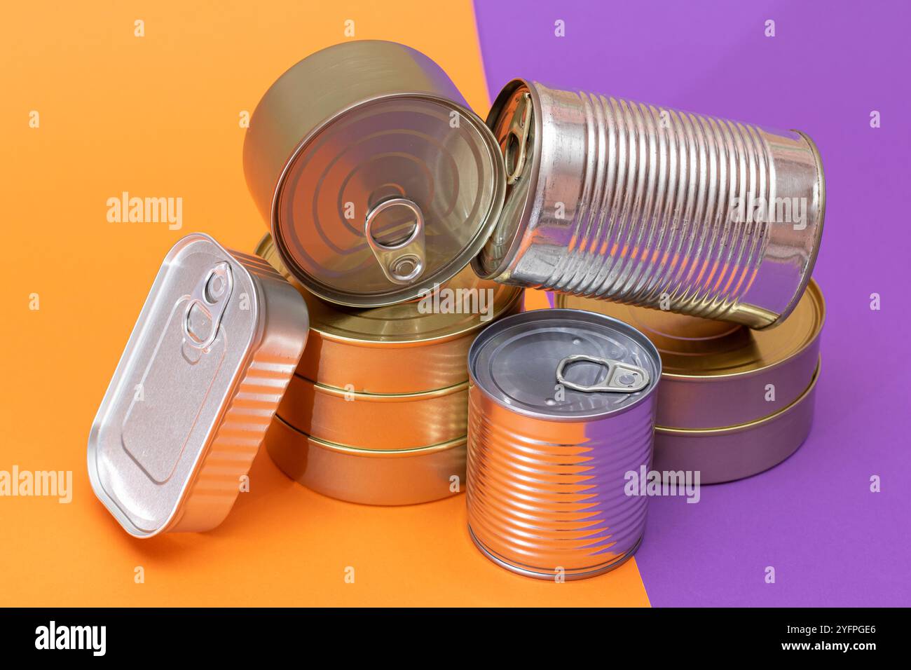 A Group of Stacked Tin Cans with Blank Edges on Split Orange and Violet ...