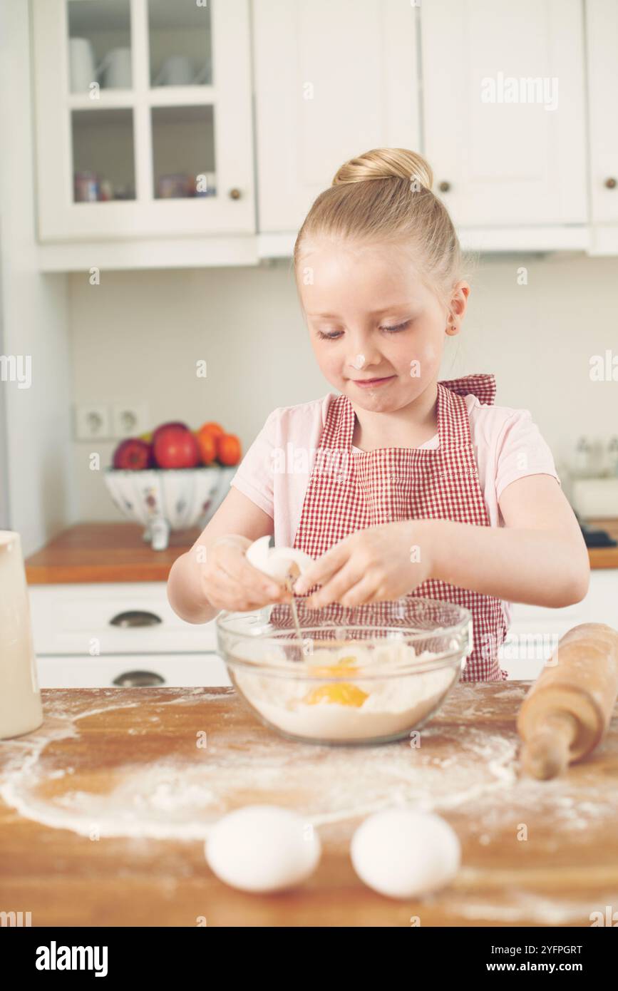 Baking, happy and child in kitchen with eggs for learning to bake cake ...