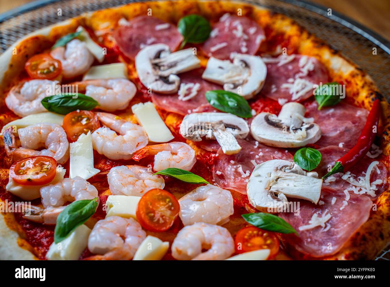 Pizza with two types of toppings: one half of pepperoni with mushrooms ...