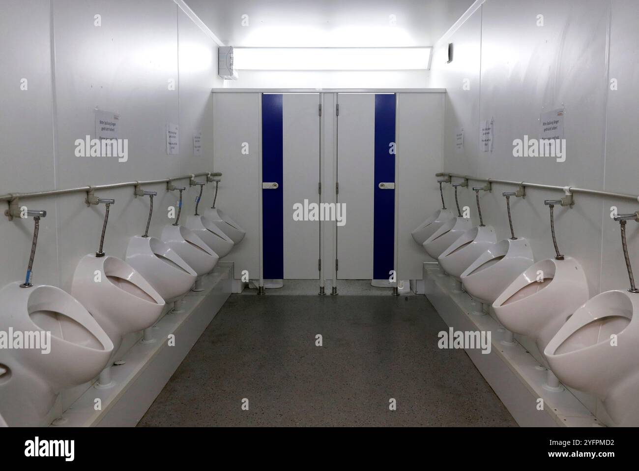 Modern public toilet for men. Clean and hygienic urinal from white ...