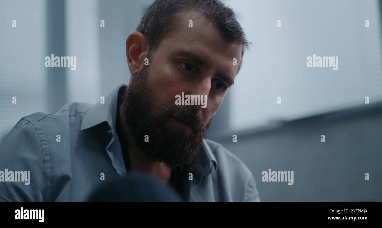 Close up of frustrated office worker sitting on the floor, breathing ...
