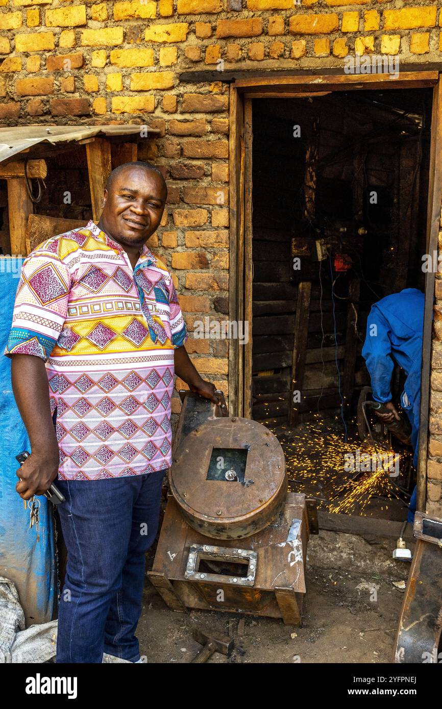 Congolese man standing outside a workshop he owns in Bukavu, DRC Stock ...