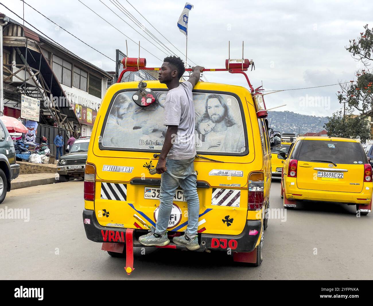 Fare collector on a bus in Bukavu city center, DRC Stock Photo - Alamy