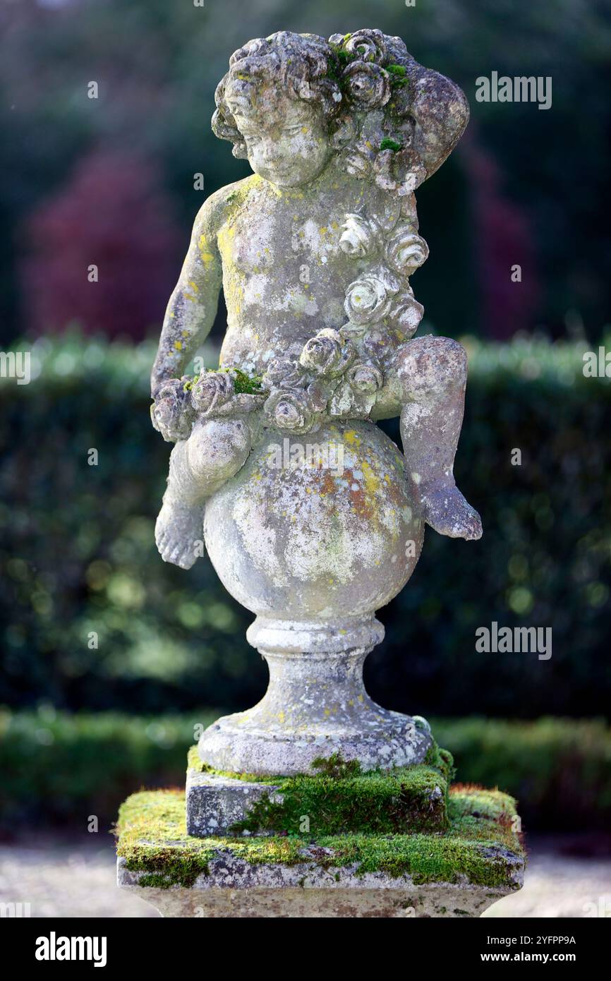 Stone scupture in a park. Child with roses. France Stock Photo - Alamy
